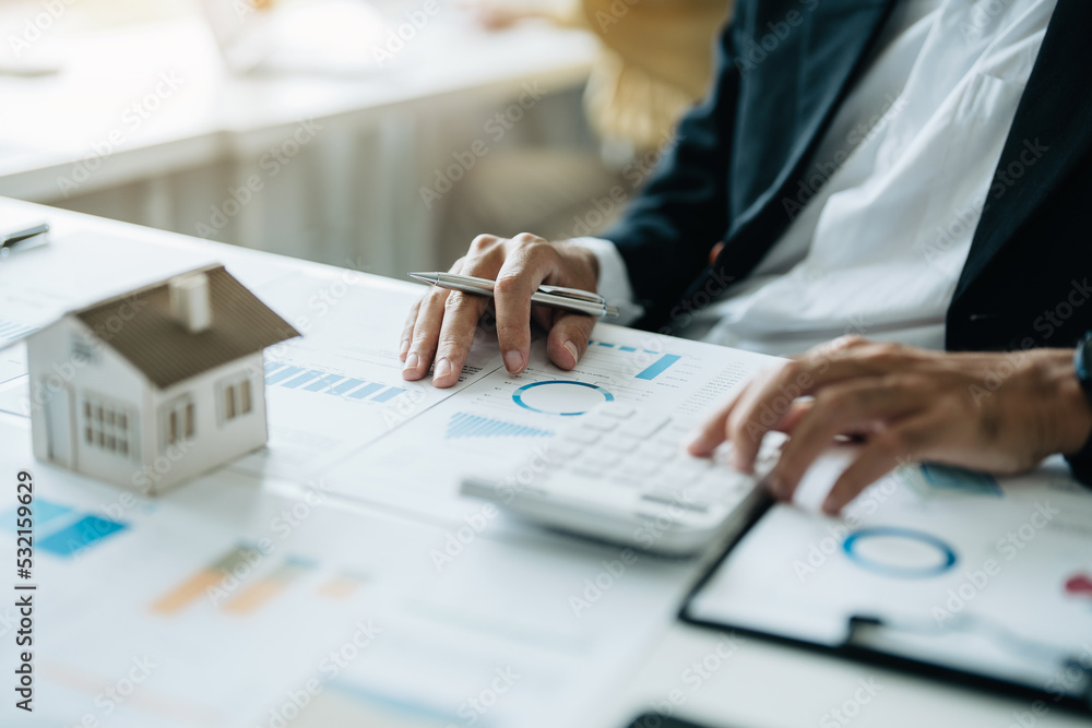 Bank loan workers are using calculators to calculate home loan interest ...