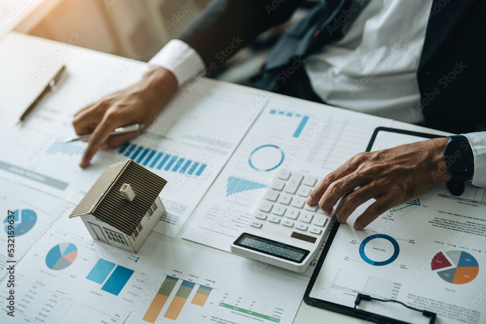 Bank loan workers are using calculators to calculate home loan interest ... Bank loan workers are using calculators to calculate home loan interest ...