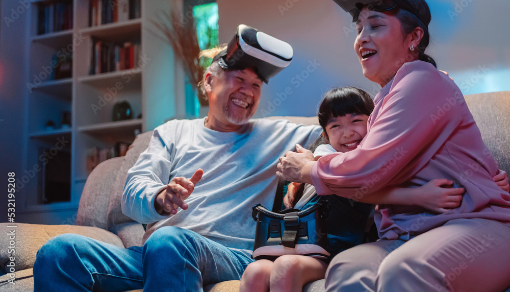 Happy family gamer of little granddaughter and grandparents in vr ...