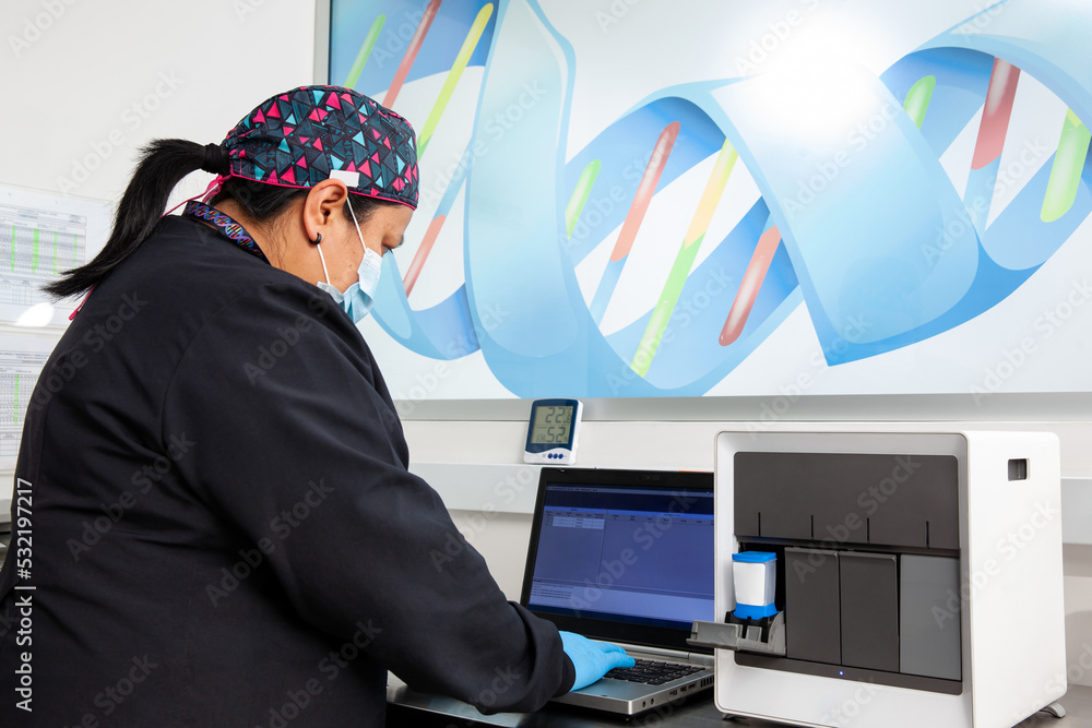 Female scientist working at the laboratory with a thermal cycler ...