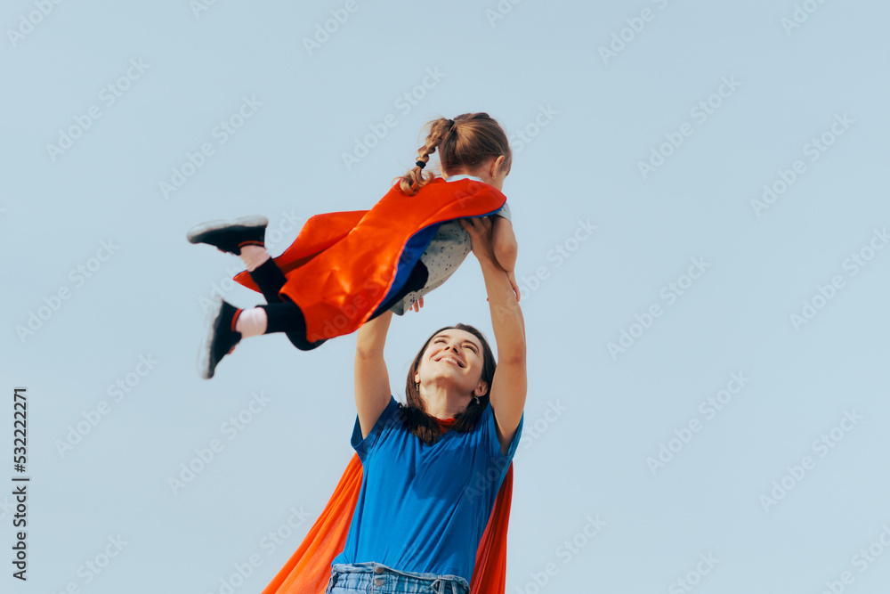 Mother Playing with Her Toddler Raising her up to the Sky. Mom lifting ...