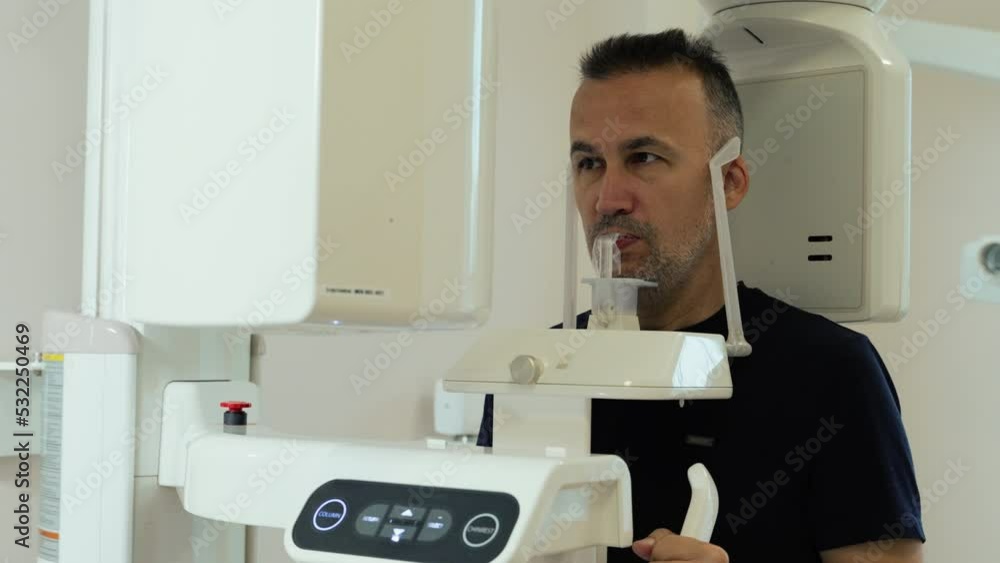 Panoramic scan of man's jaw by x-ray scanner in dental clinic. Scanner ...