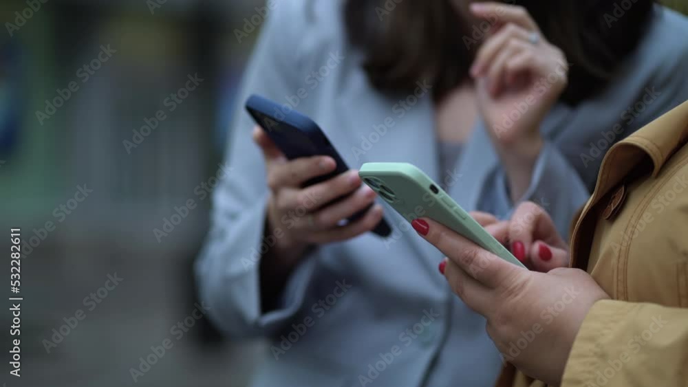 Close up focus on females hands using phones. Two women with ...