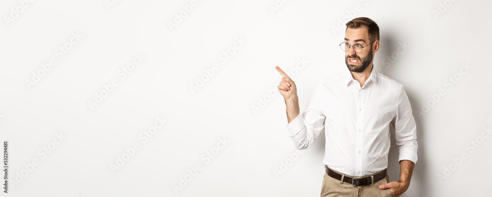 Young bearded guy seeing something disturbing, cringe while pointing ...
