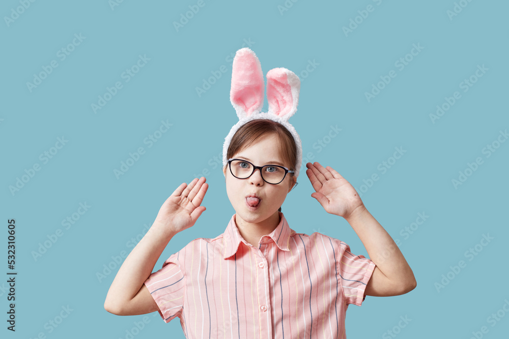 Portrait of teen girl with Down syndrome wearing Easter bunny ears ...