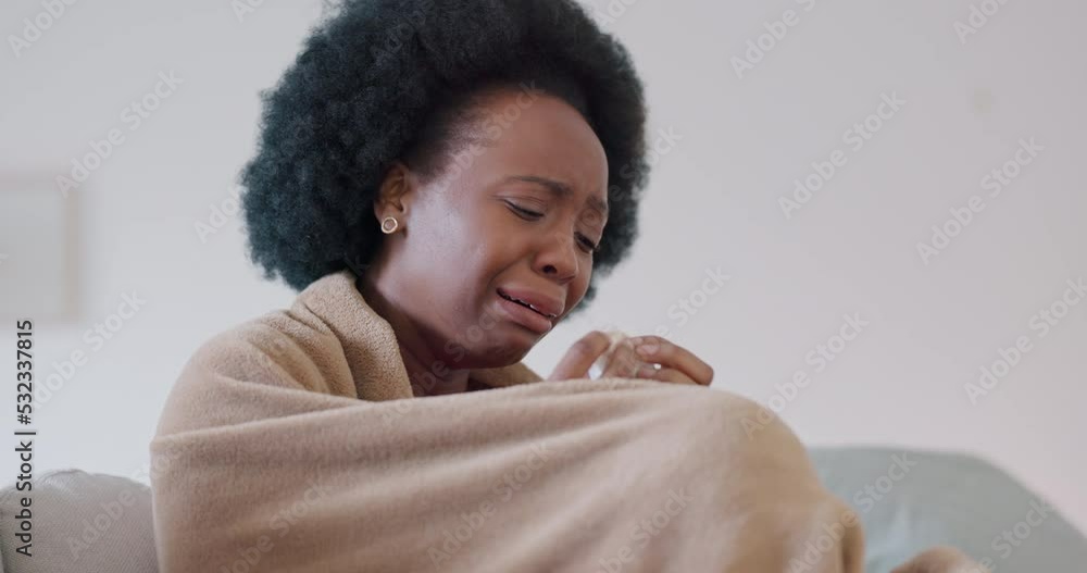 Sad crying black woman with depression at home on couch, sofa or living ...