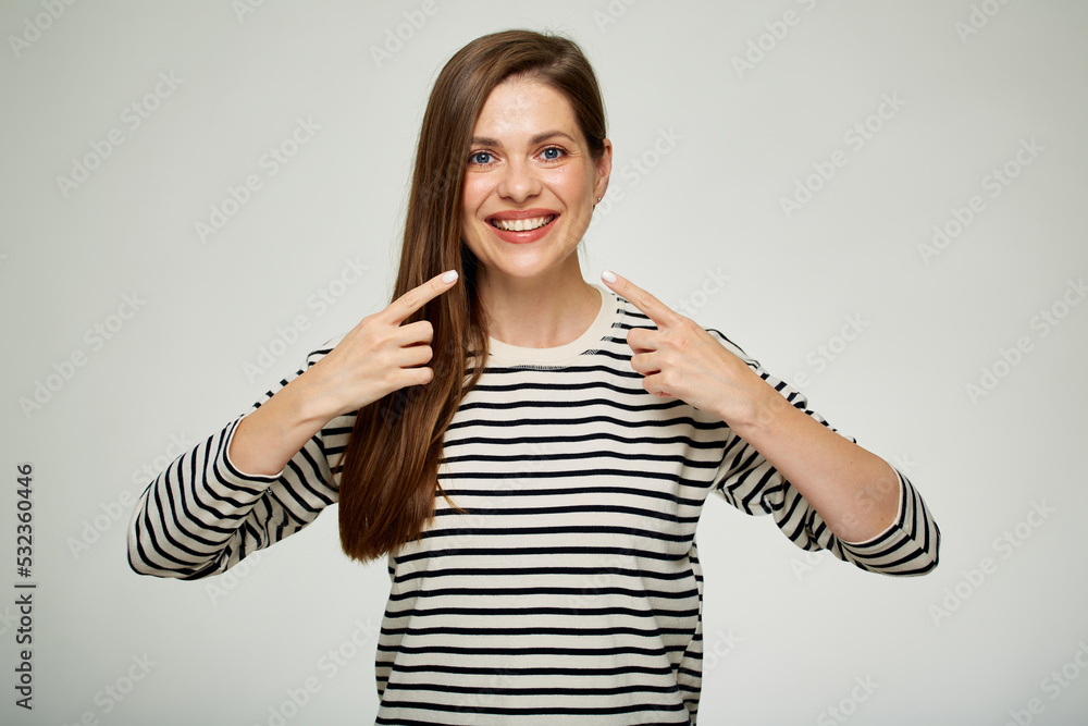 Young woman pointing at toothy smile with white teeth. Isolated ...