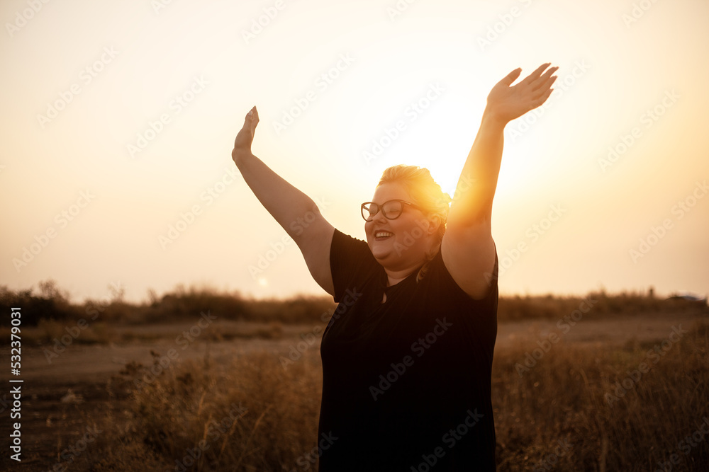 Beautiful overweight woman of xl size dressed in a black dress posing ...