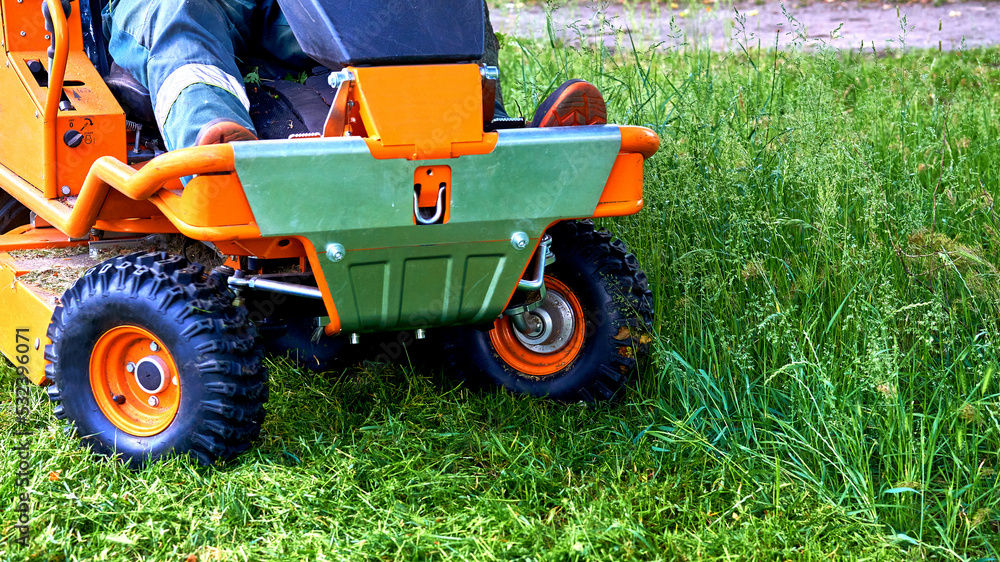 Professional grass cutting on lawns with a mini tractor lawn mower ...