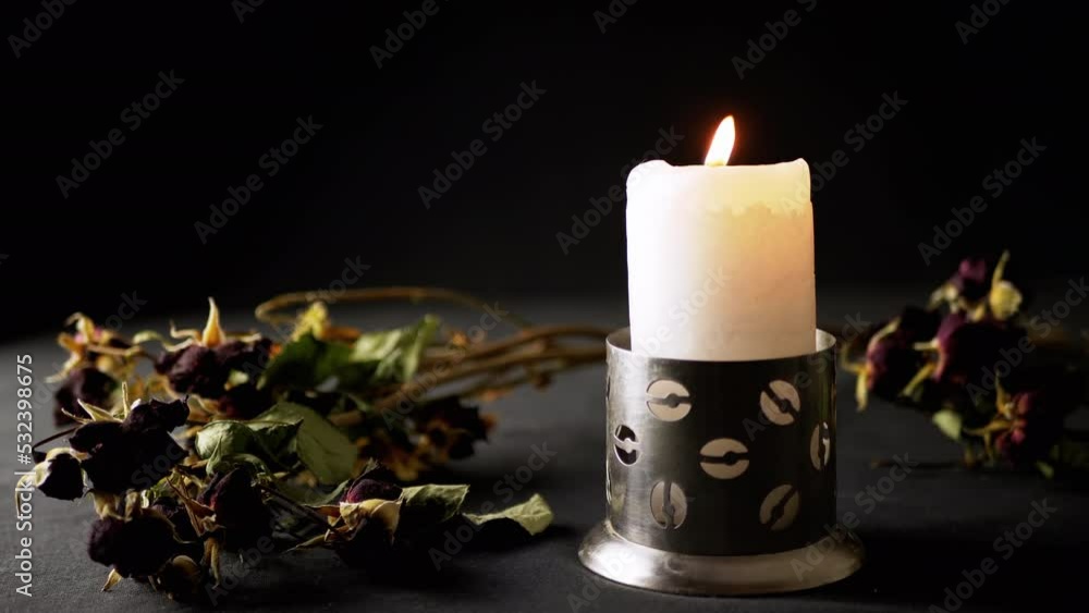 Burning Candle Flame with Withered Dry Flowers on Table on Black ...