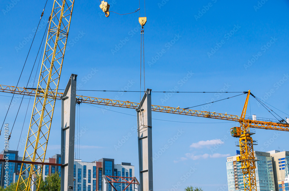 Installation of metal supports for the stadium stands using a crane ...
