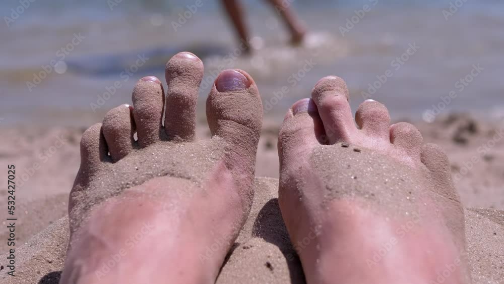 Tanned Red Bare Female Feet in Sand Lies on a Sandy Beach on Coast of ...
