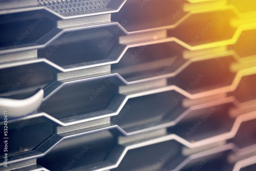 Grill grid of car macro chrome detail pattern background with sun flare ...