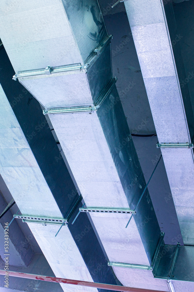 Air conditioning in buildings. Background of ventilation pipes. Laying ...