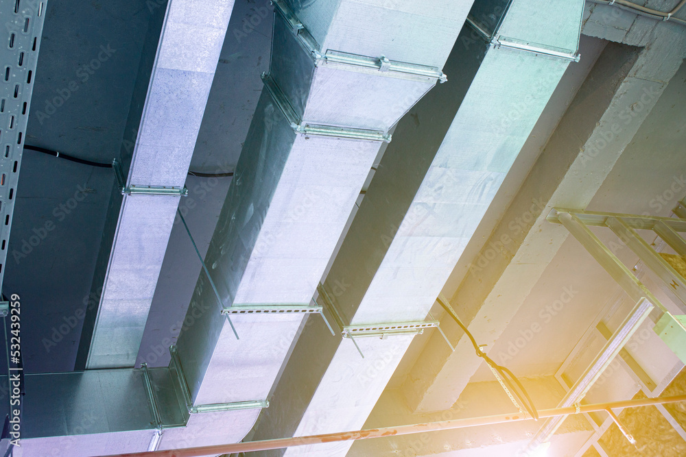 Air conditioning in buildings. Background of ventilation pipes. Laying ...