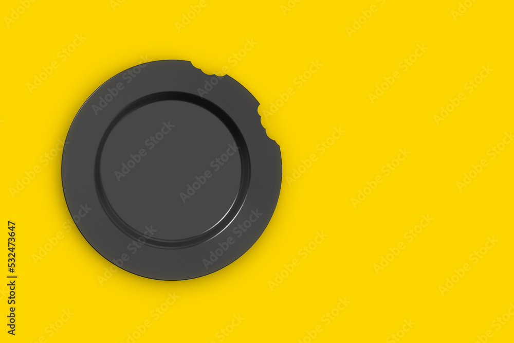 bitten black plate on a yellow background. Teeth marks. Food crisis ...