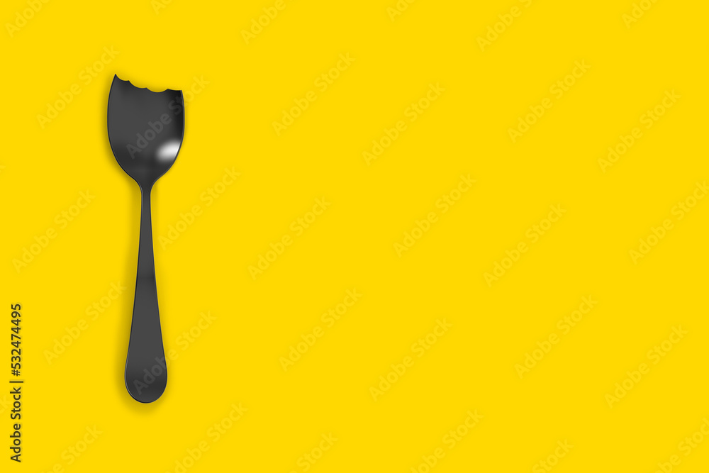 bitten black spoon on a yellow background. Teeth marks. Food crisis ...