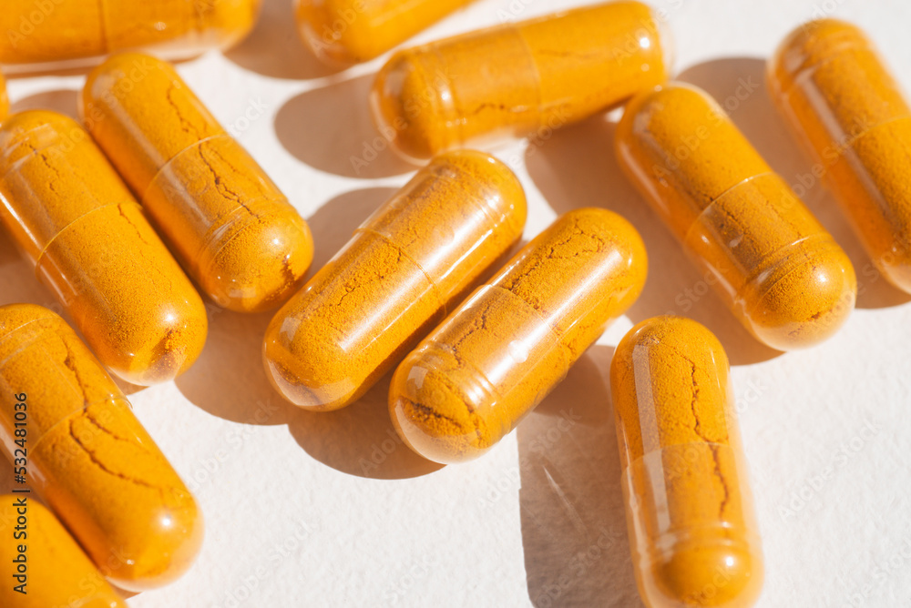 Turmeric plus black pepper extract gelatin capsules close up top view ...