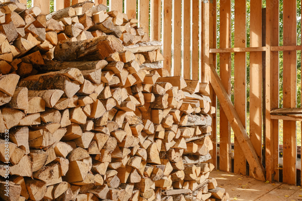 Stack of firewood. Wooden shed for storing firewood indoors. Firewood ...