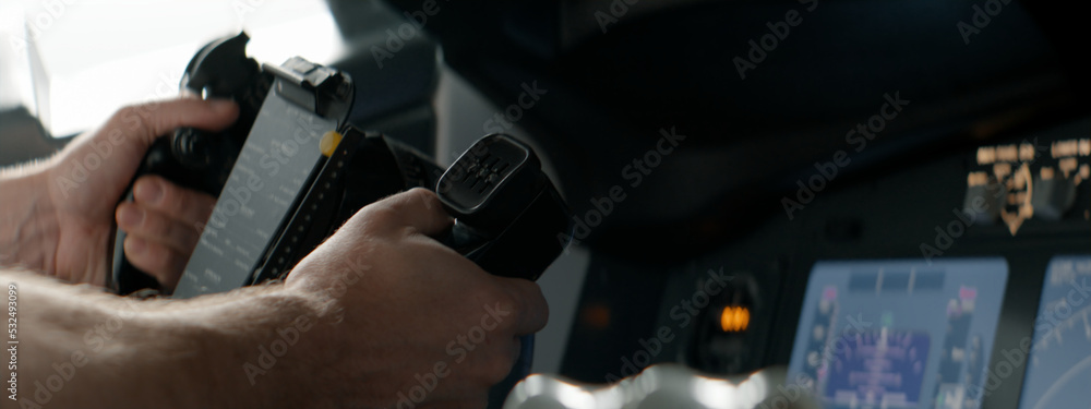 CU Commercial aircraft pilots controlling the yoke of the airplane ...