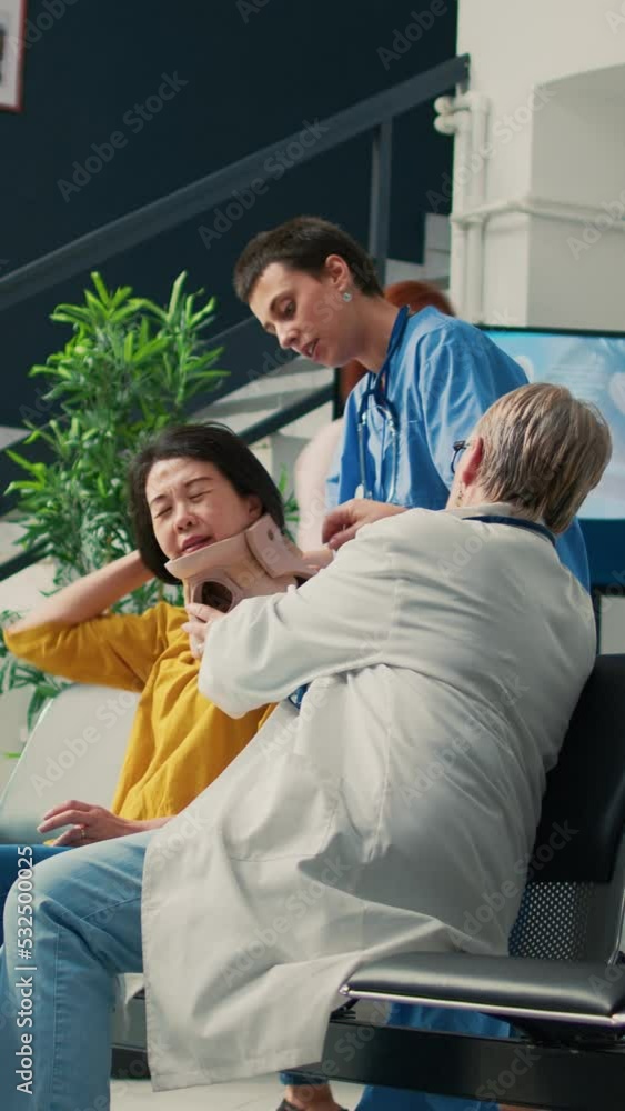 Vertical video: Nurse and medic helping old patient with cervical neck ...