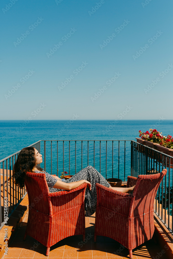 Sunbathing in rooftop terrace with views of the sea. Summer holidays ...