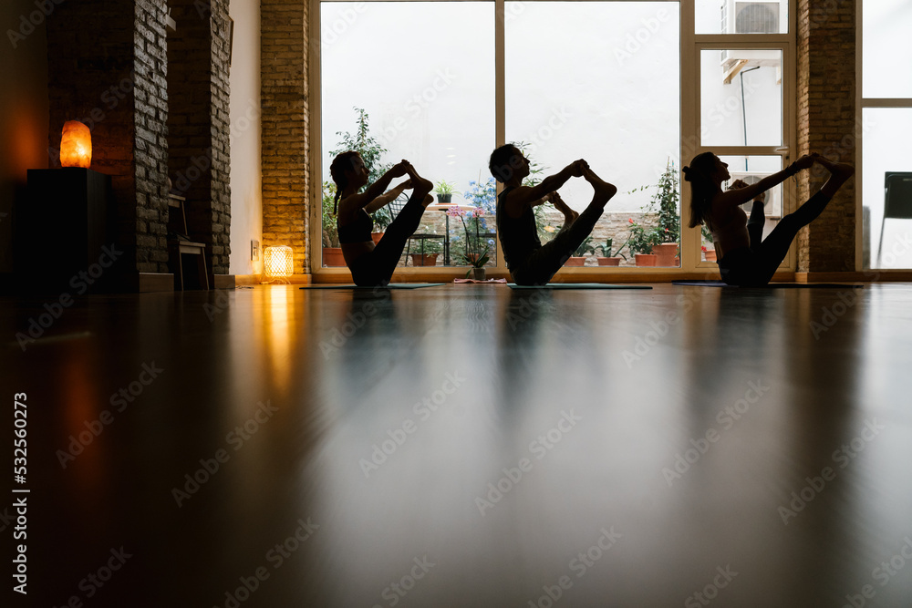 People doing Boat with Toe Hold Stock Photo | Adobe Stock