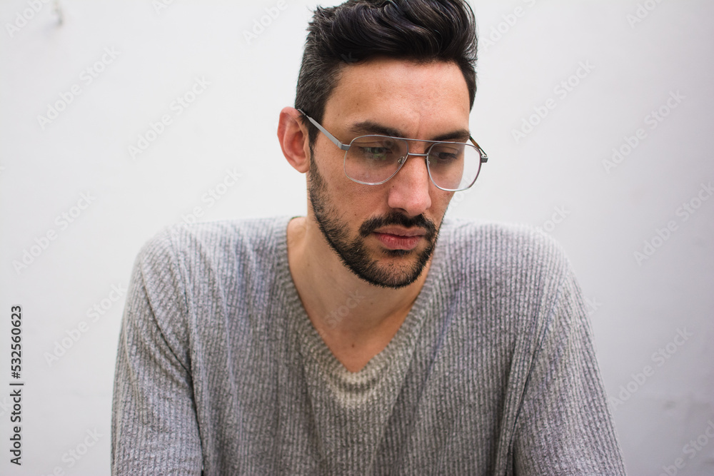 Sad man looking down with pensive expression Stock Photo | Adobe Stock
