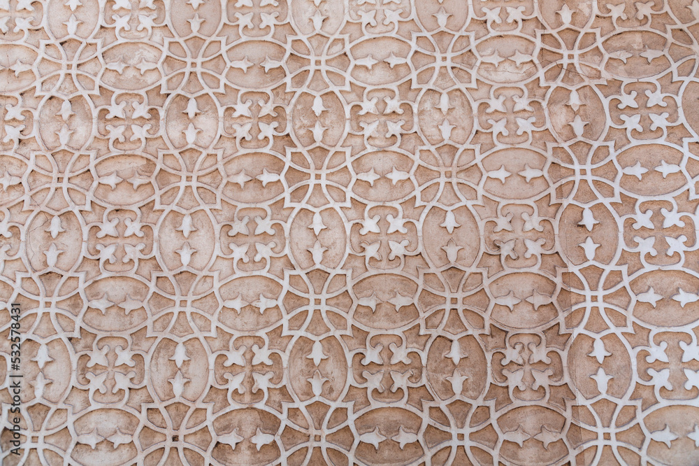 Texture background from a stucco wall covered with traditional patterns ...