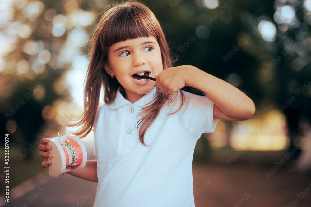 Toddler Girl Brushing Teeth Holding Dental Orthodontic Model with ...