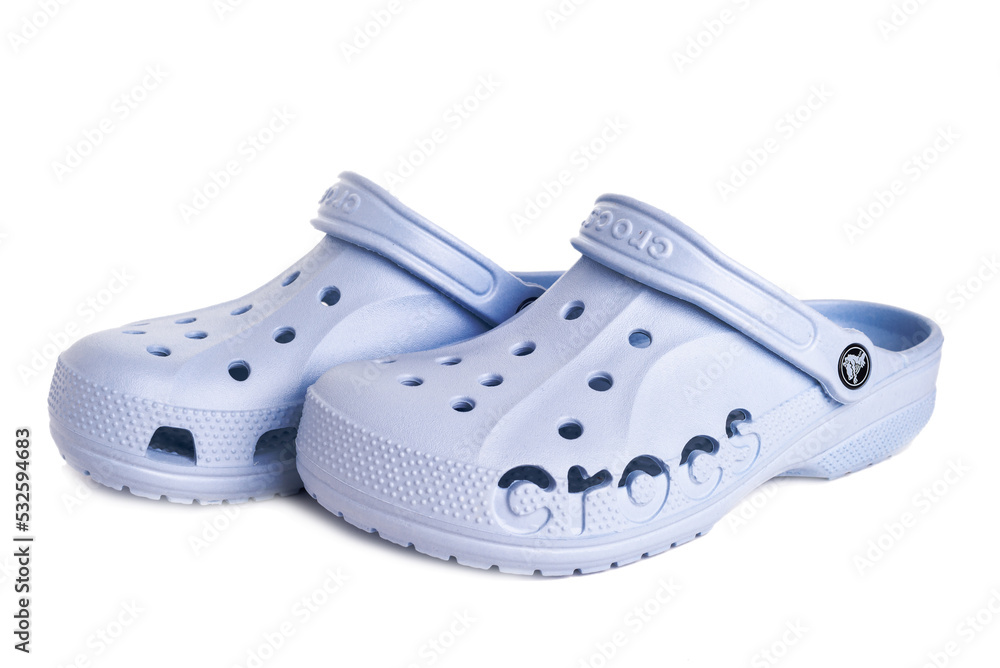 pair of blue Crocs sandals with a distinctive design on a white ...