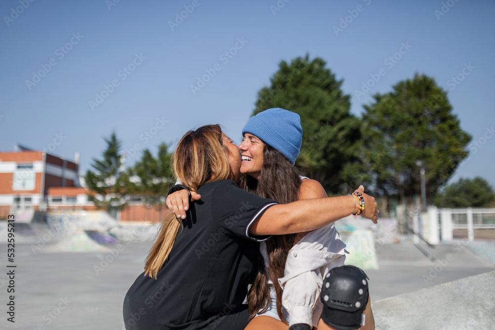 friends giving each other a hug in a skate park in the city Stock Photo ...
