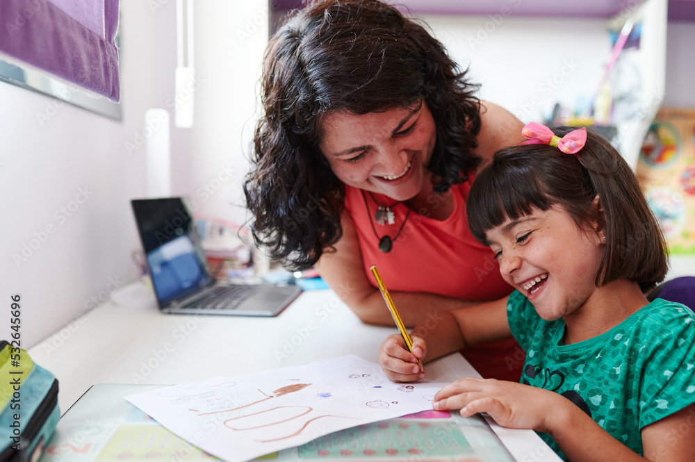 Laughing mom and girl drawing pictures Stock Photo | Adobe Stock