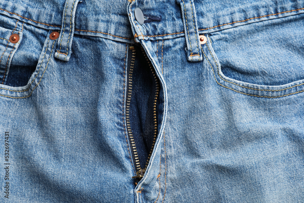 Blue jeans with unbuttoned fly as background, top view. Exhibitionist ...