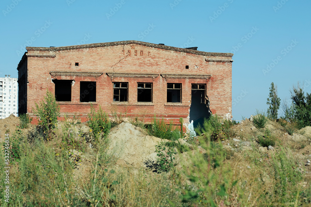 the ruins of an old rare destroyed building of the Soviet era against ...