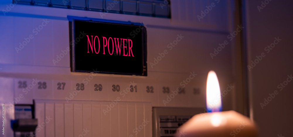 Electrical switch box panel with the text "no power" and burning candle ...