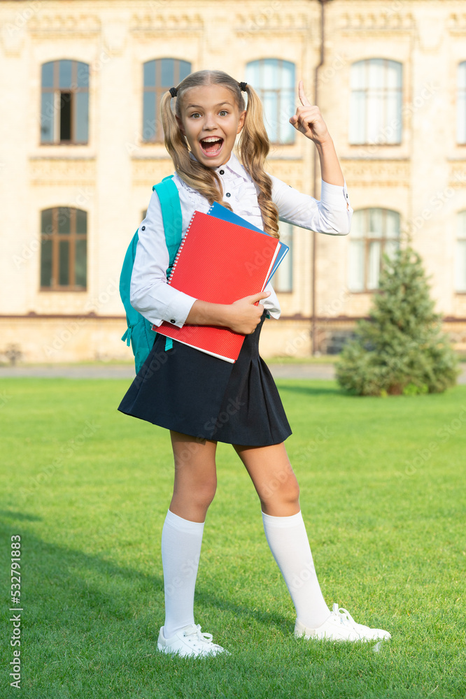Excited girl making winning gesture, school. Happy teenage girl in ...