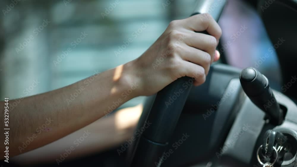 Driver hands holding steering wheel driving car on road. Closeup of ...