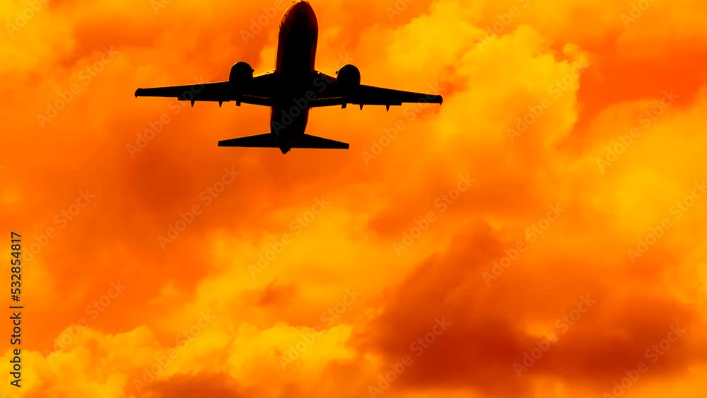 Dark silhouette of large passenger airplane, airliner is flying in the ...