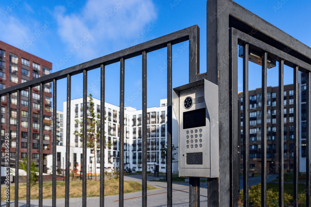 Electronic lock with buttons and intercom on the metal fence gate ...