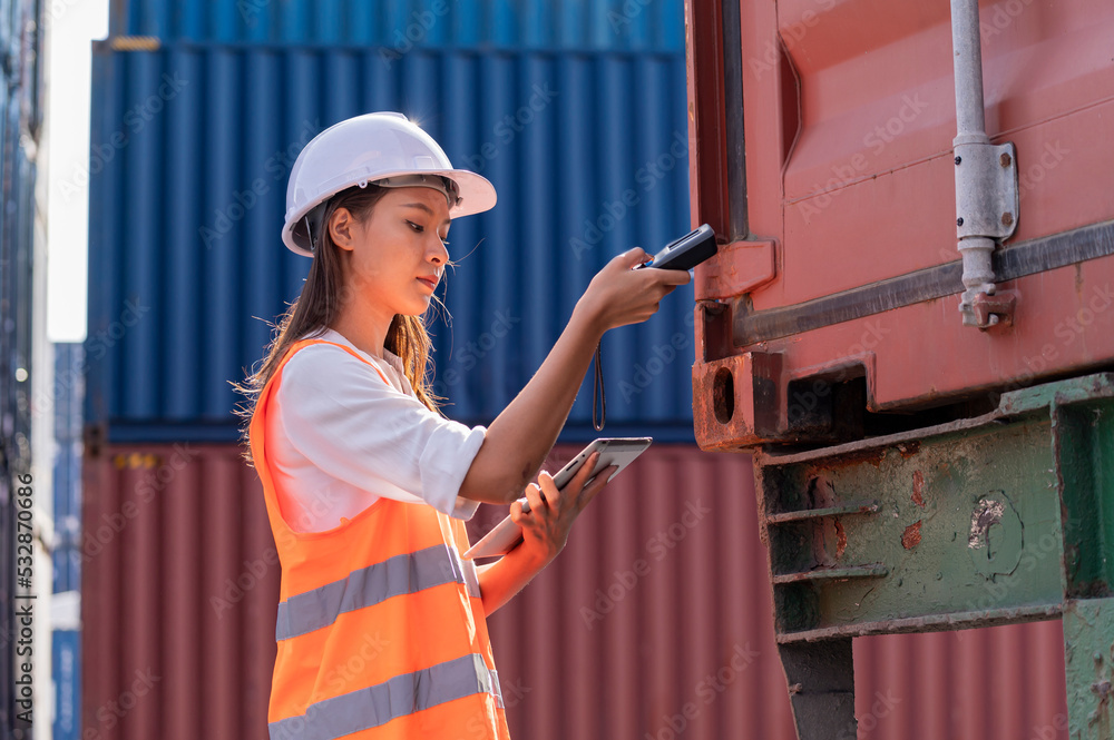 Smile Asian woman logistics worker wear safety helmet and protect suite ...