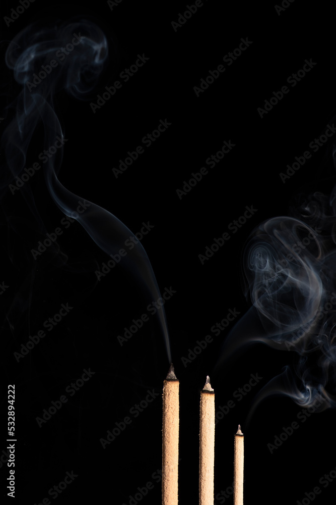 Temple incense sticks showing smoke trails and dramatic patterns due to ...