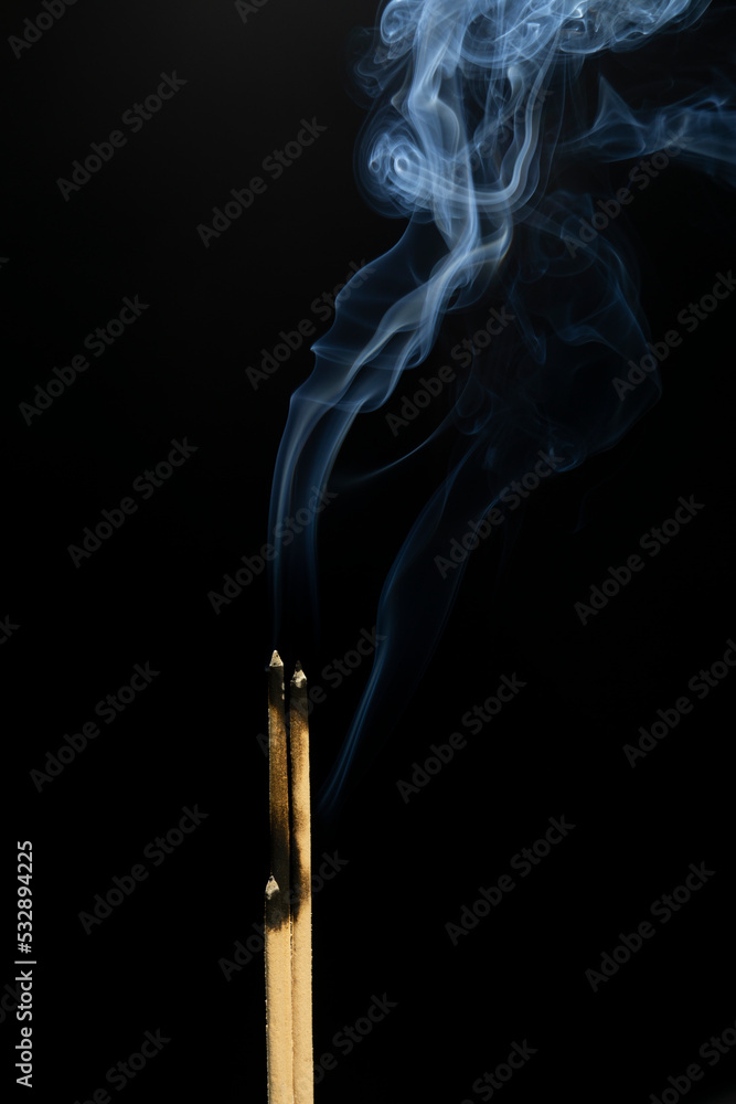 Temple incense sticks showing smoke trails and dramatic patterns due to ...