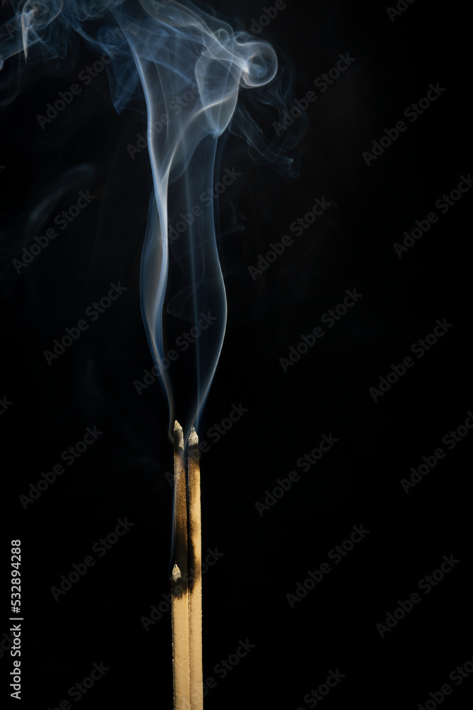 Temple incense sticks showing smoke trails and dramatic patterns due to ...