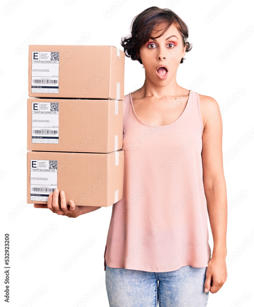 Beautiful young woman with short hair holding delivery packages scared ...