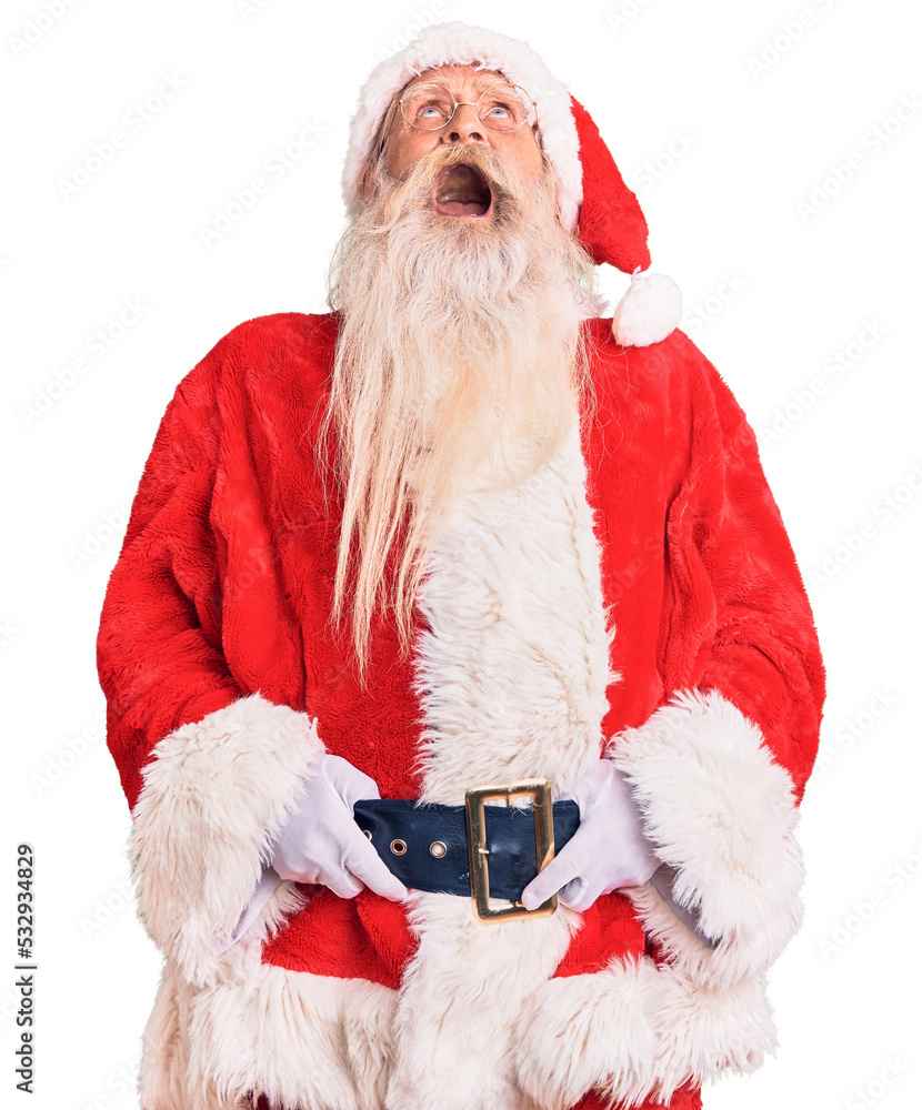 Old senior man with grey hair and long beard wearing traditional santa ...