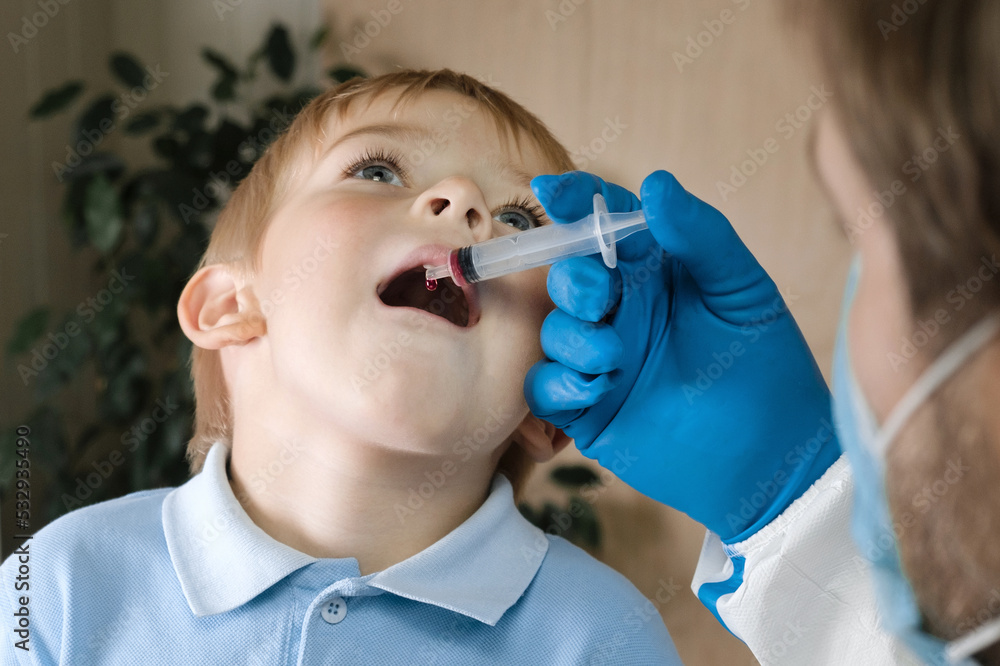 Kid getting polio drops. Doctor making to Child Oral Vaccination ...