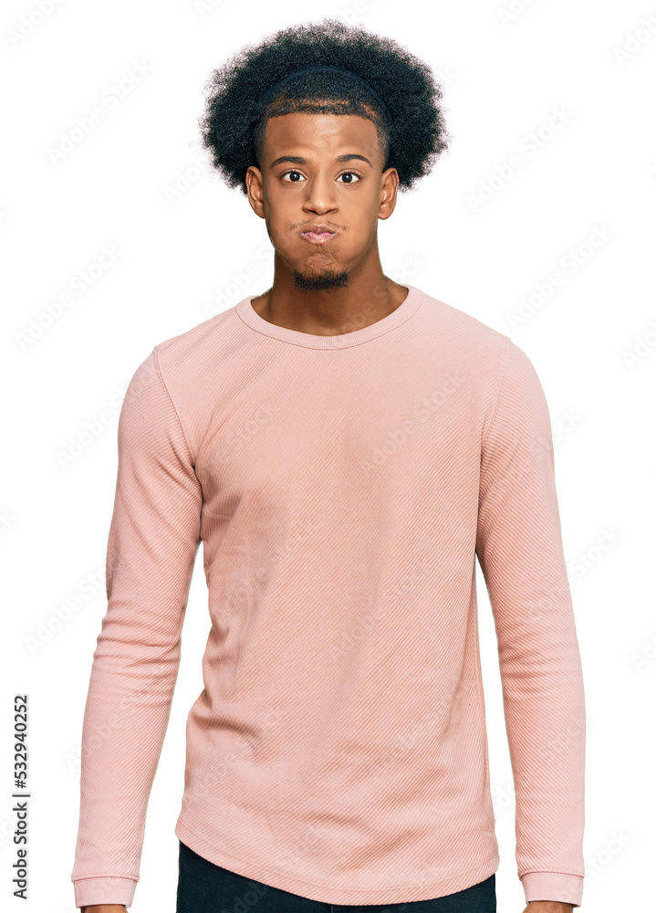 African american man with afro hair wearing casual clothes puffing ...