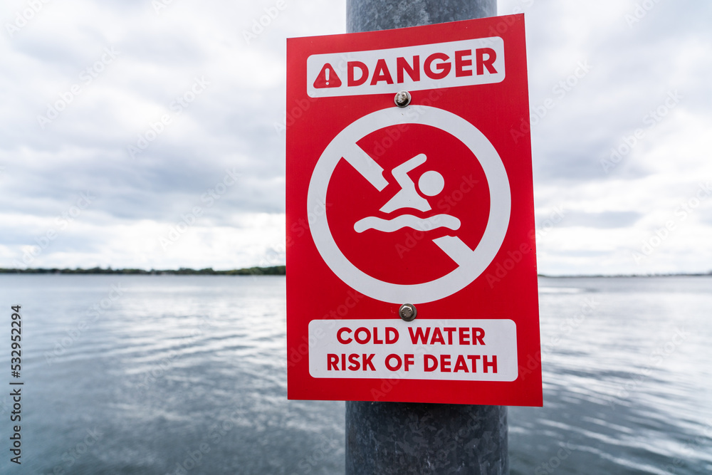red Warning sign located at waterfront to inform people, "Danger - Cold ...