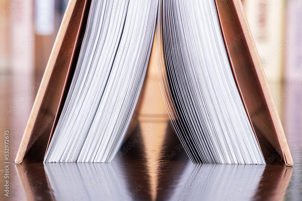 Upside down open book on desk in library Stock Photo | Adobe Stock